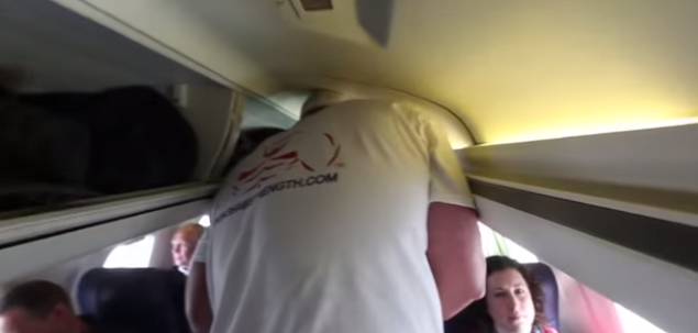 Watch As A 6'8" Strongman Struggles To Fit On An Airplane