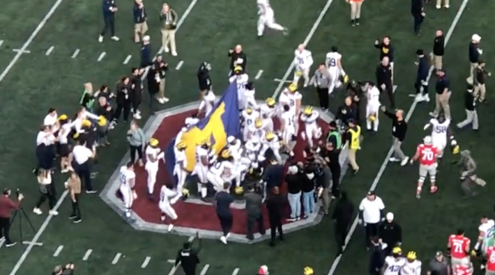 Michigan Players Plant Flag At Midfield After Beating OSU